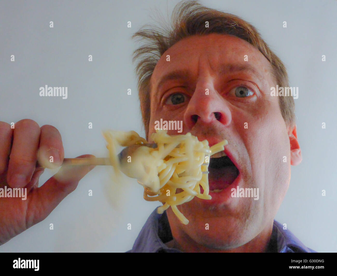 Man eating spaghetti Stock Photo - Alamy