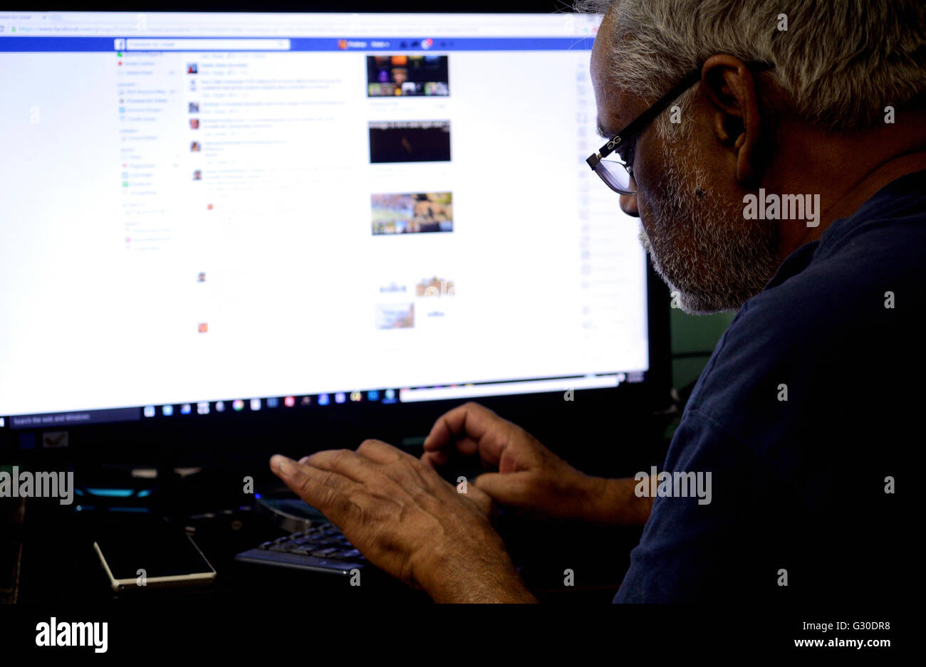 Senior Men working desktop computer at late night Stock Photo - Alamy