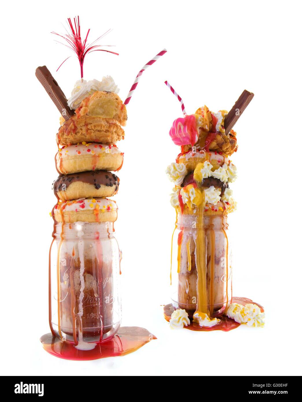 Decadent Freakshakes with ice cream and doughnuts on a white background ...