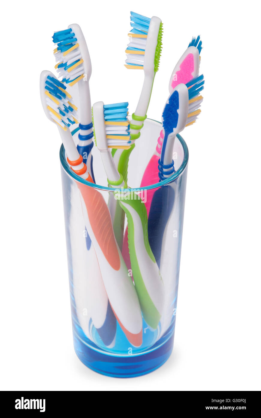 Colored toothbrushes in glass. Isolated on white background. Clipping ...