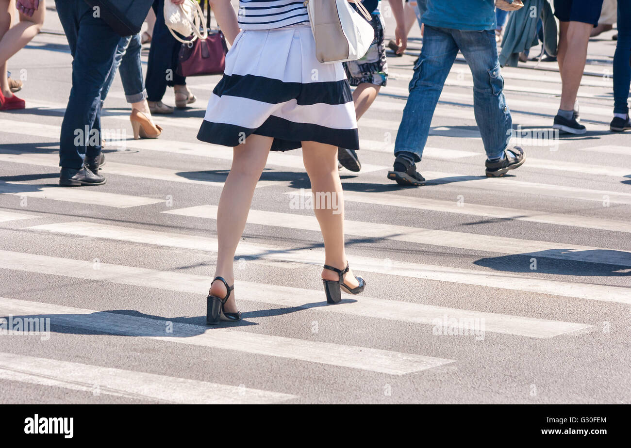pedestrians walk on a crosswalk on sunny summer day Stock Photo - Alamy