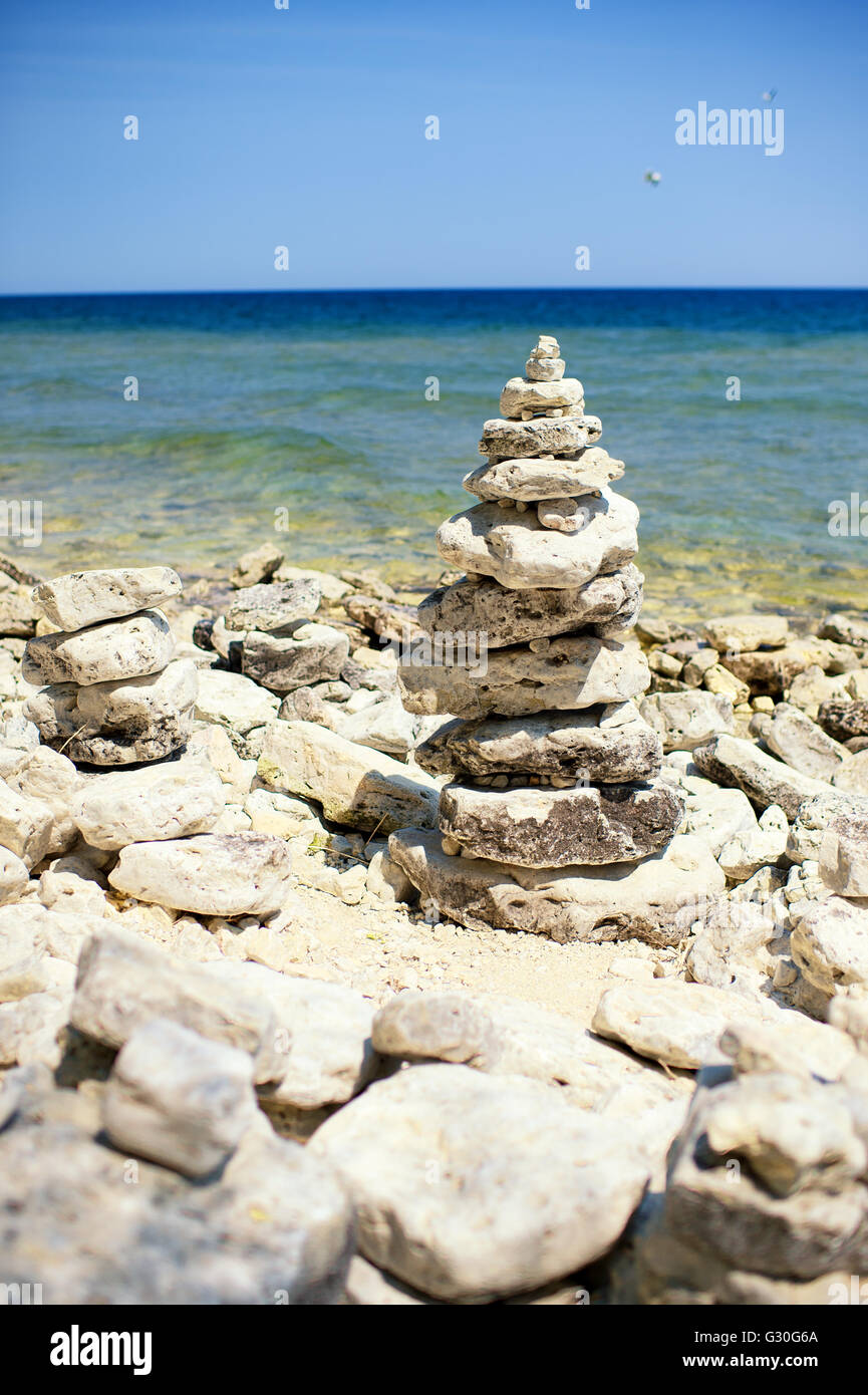 Lot of rocks stacked on top of each other along a a waterfront Stock ...