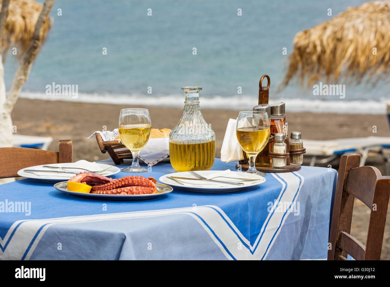 Table in a fish restaurant on the beach for two Stock Photo - Alamy