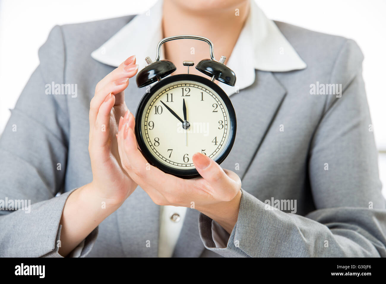 Employee holding alarm clock hi-res stock photography and images - Alamy