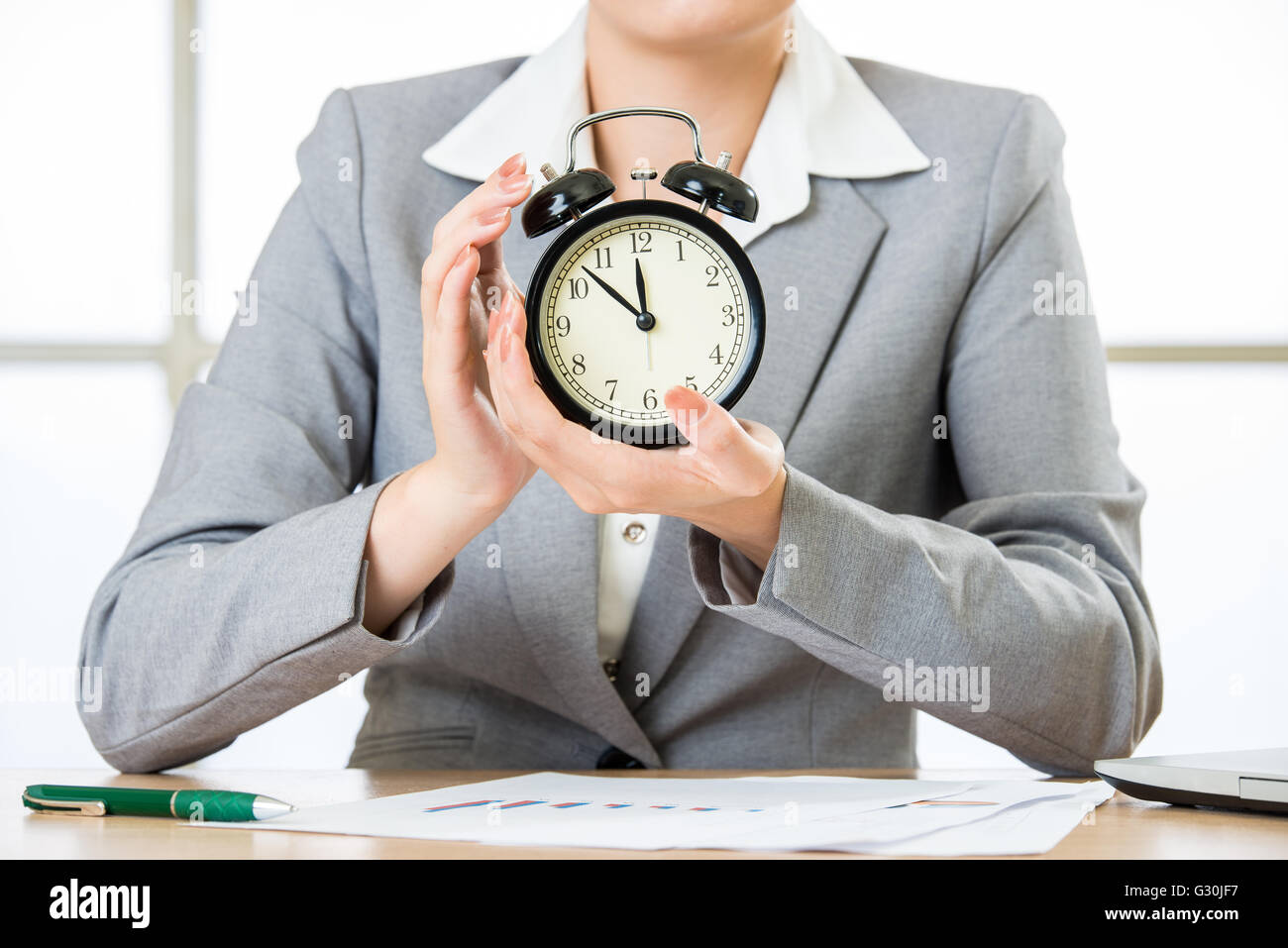Employee holding alarm clock hi-res stock photography and images - Alamy