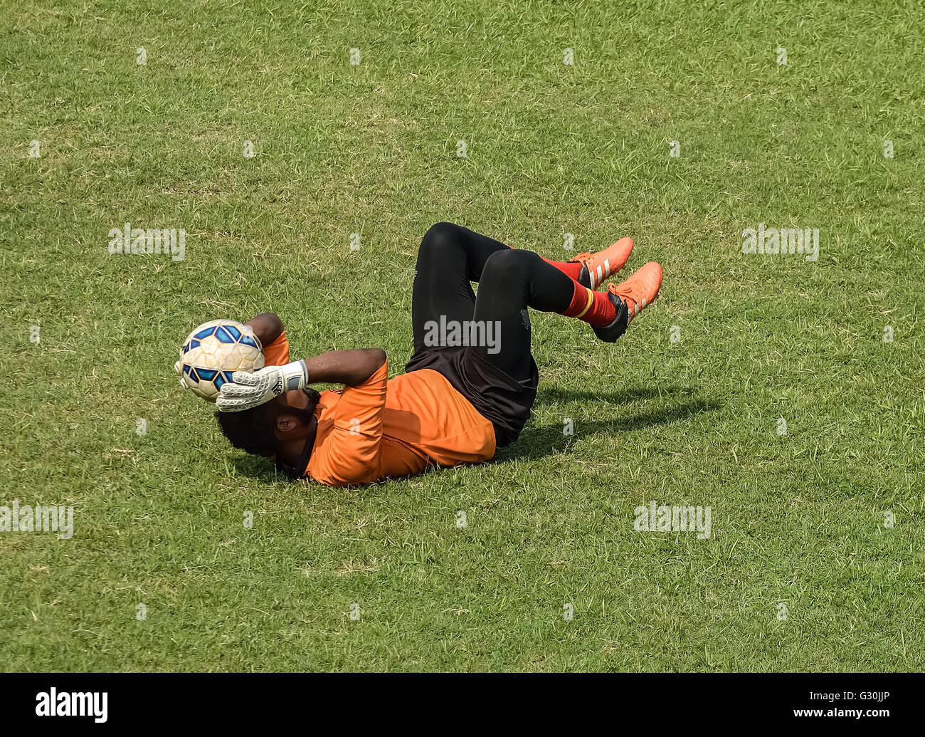 In play soccer goalkeeper is to catching a ball Stock Photo - Alamy