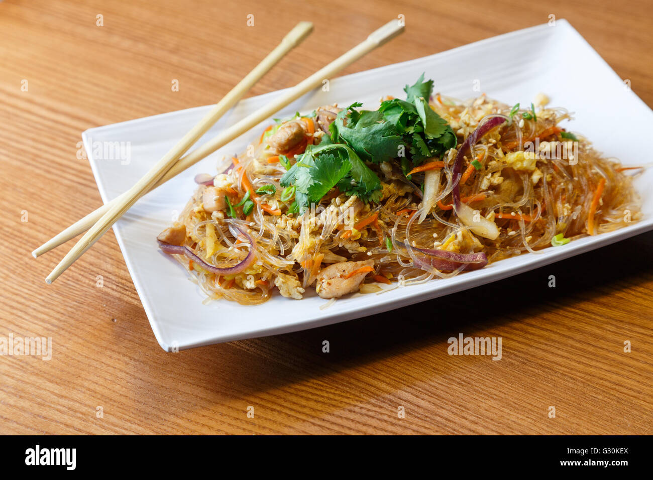 Glass noodles with chicken in rectangle plate in asian restaurant Stock ...