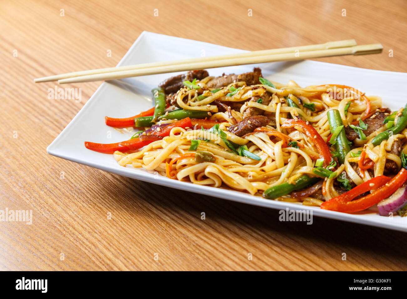 Udon noodles with beef in rectangle plate with bamboo sticks in asian ...