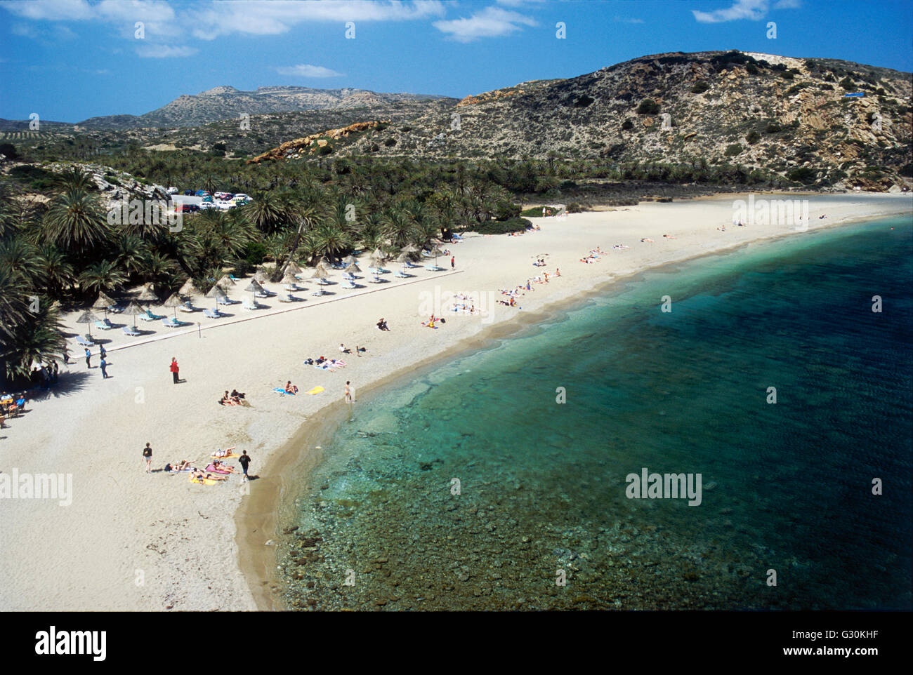 Greece, Greek Islands, Crete, Vai, visitors sunbathing on beach ...
