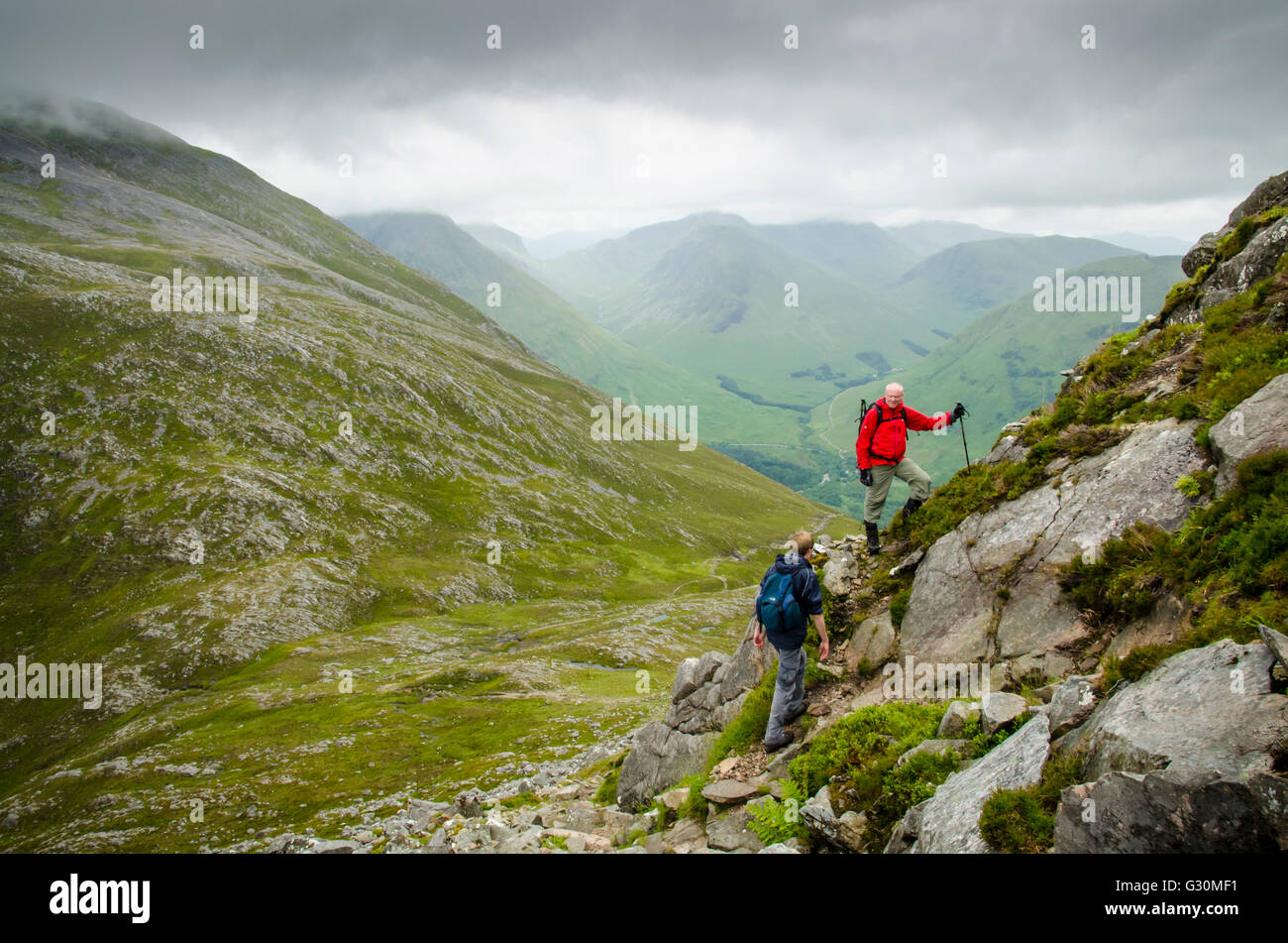 Father and son walking up Pap of Glencoe, Scotland, United Kingdom ...