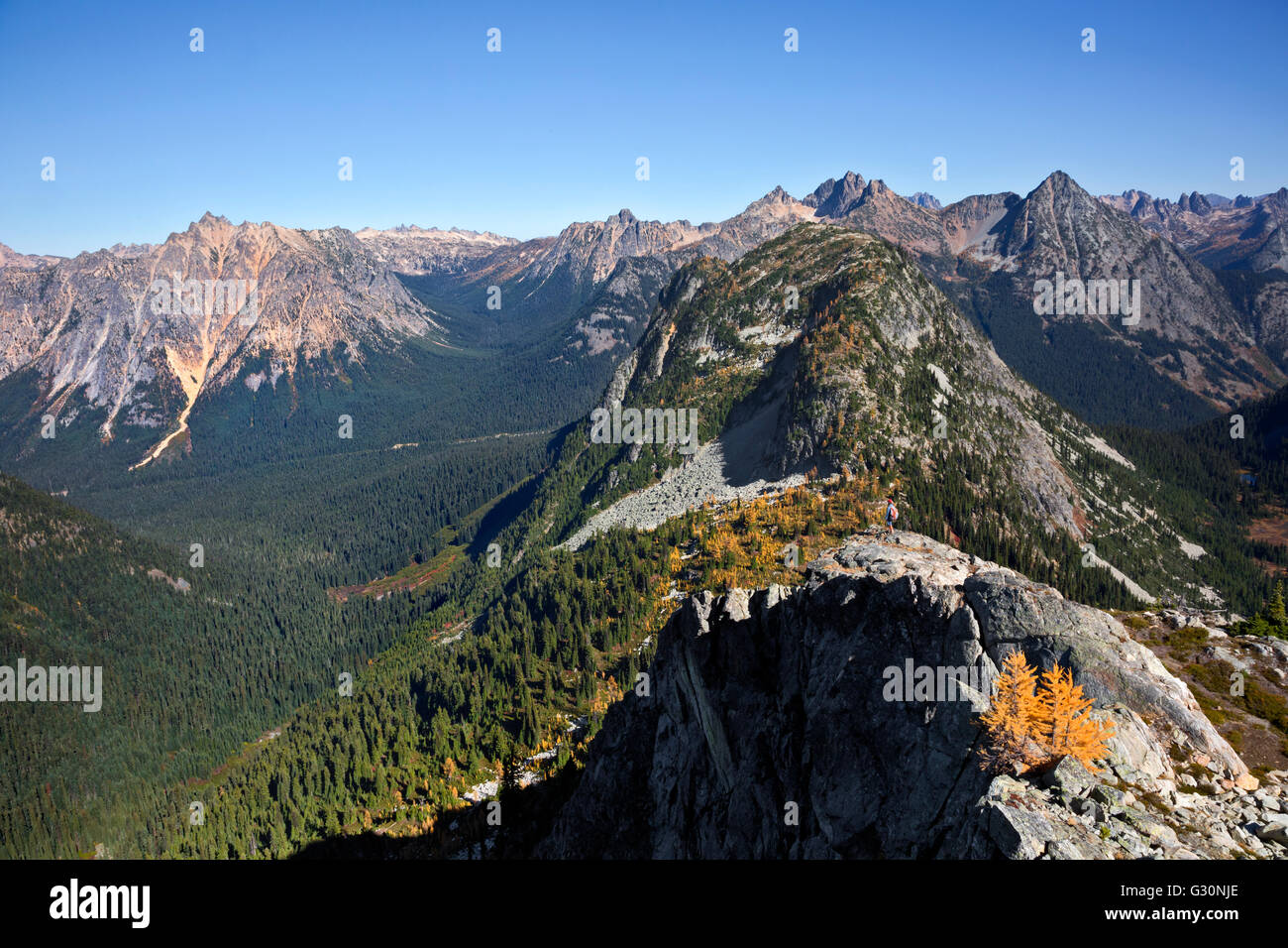 WASHINGTON - Hiker exploring off-trail from Maple Pass overlooking ...