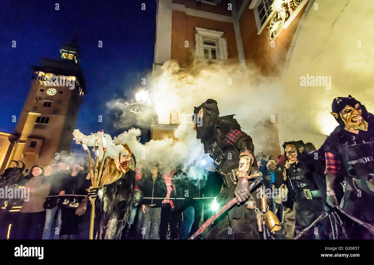 Perchtenlauf (mask procession) with Krampus in the main square in front ...