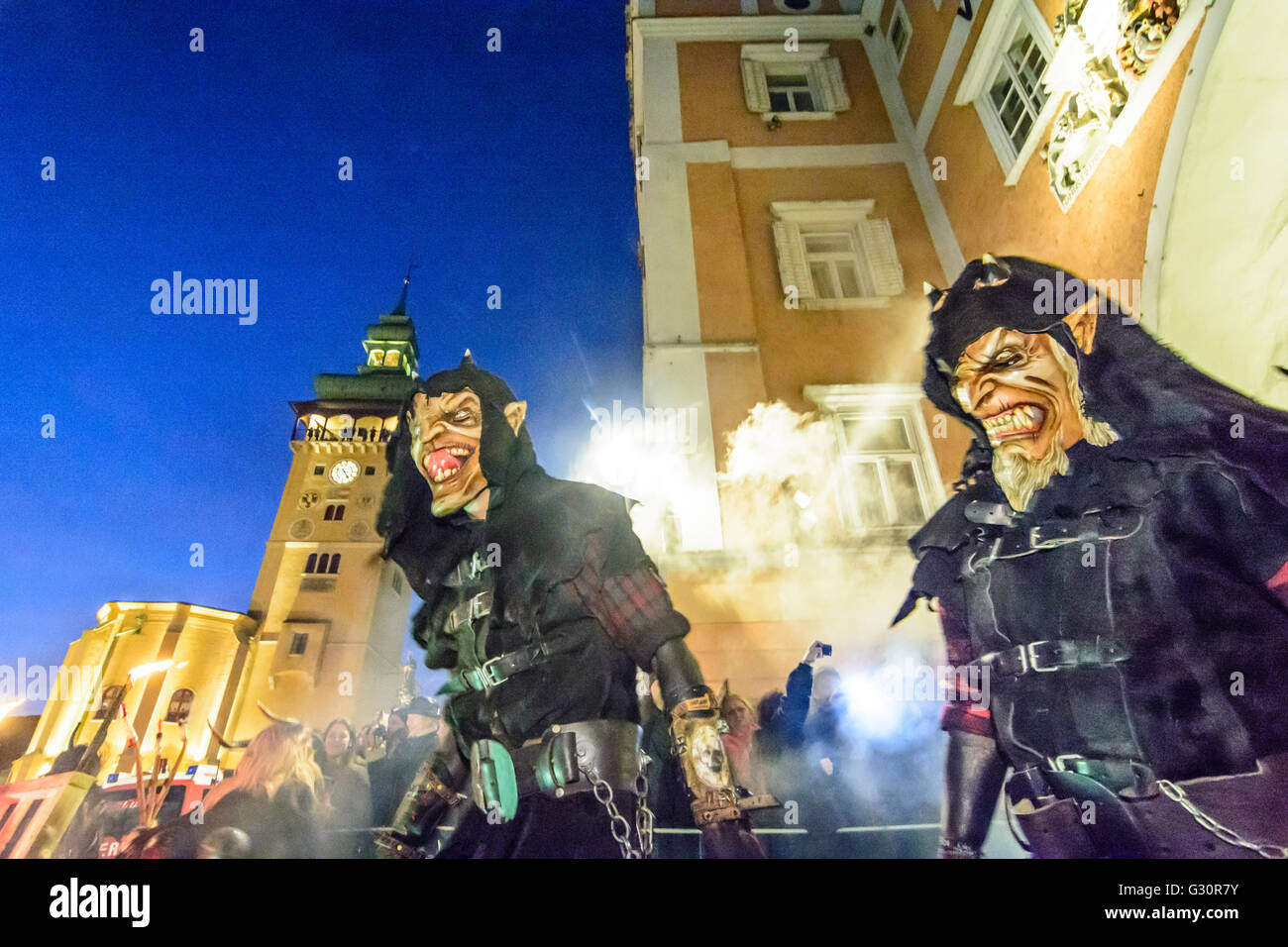 Perchtenlauf (mask procession) with Krampus in the main square in front ...