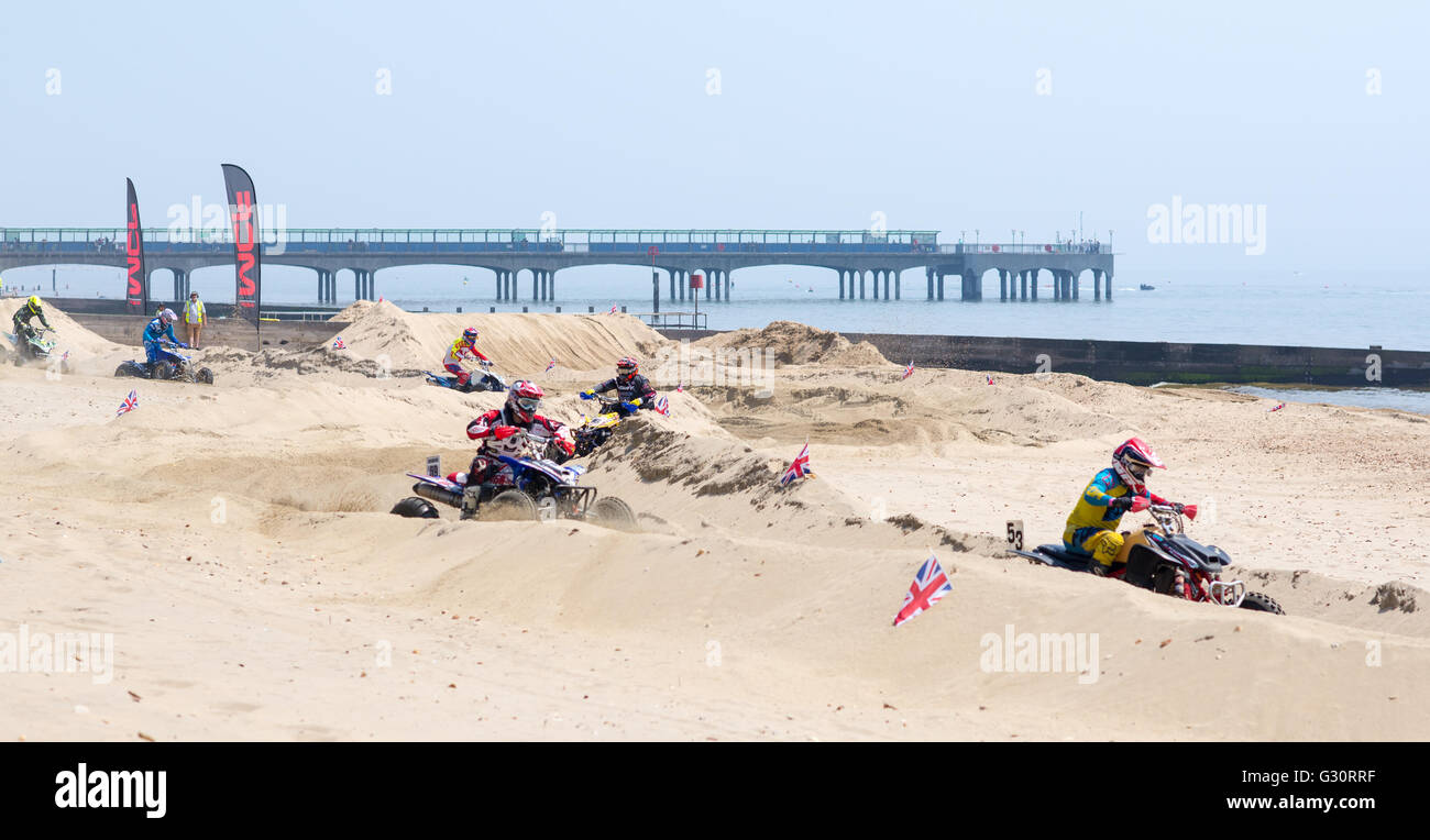 Quad bike racing around a prepared circuit at the Bournemouth Wheels ...
