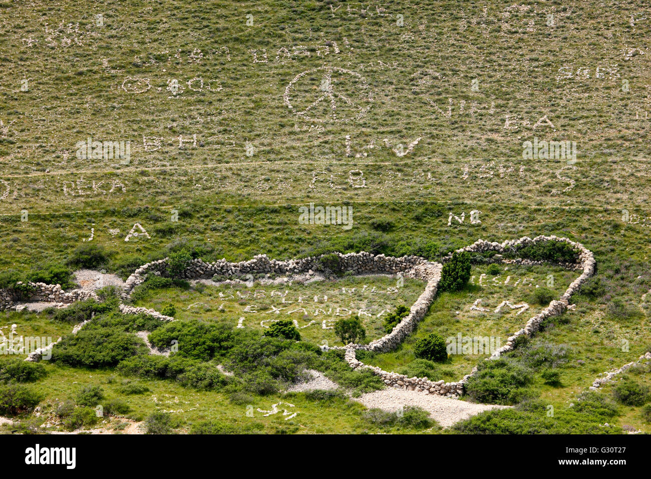 Giant rock letters on meadow made by tourists Stock Photo - Alamy
