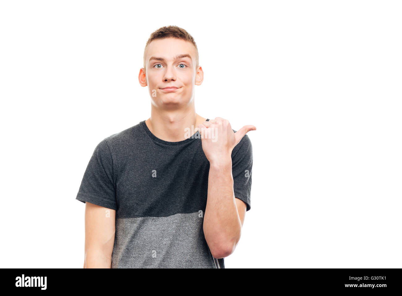 Shocked casual man pointing finger away isolated on a white background ...
