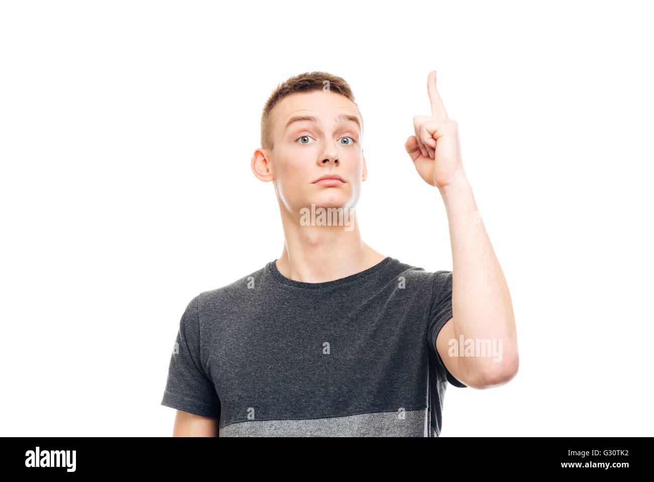 Young man pointing finger up isolated on a white background Stock Photo ...
