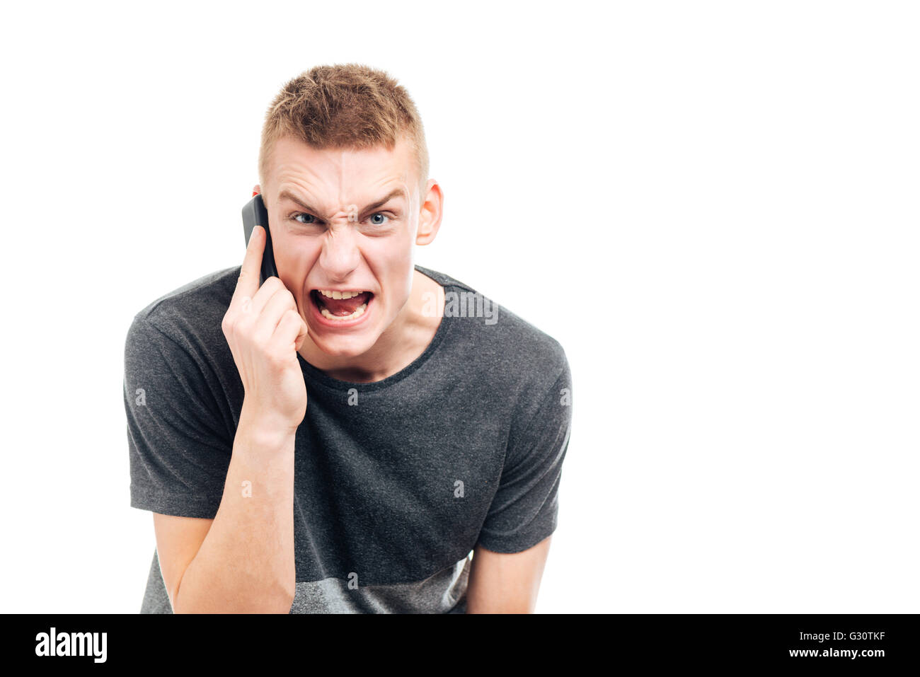 Angry man talking on the phone isolated on a white background Stock ...