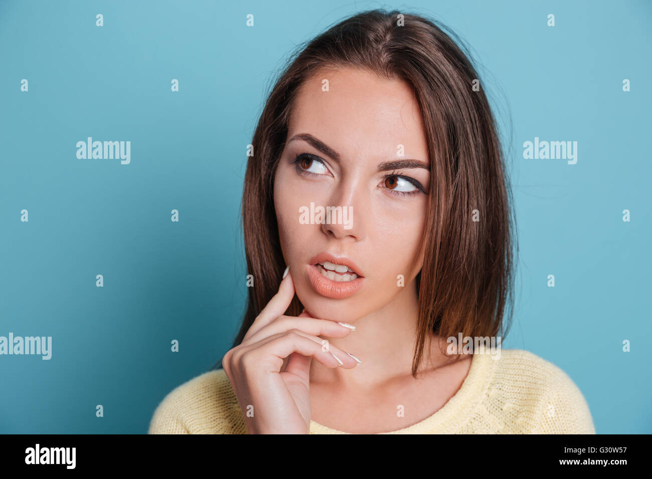 Close-up portrait of a pensive thougtful pretty girl thinking about ...