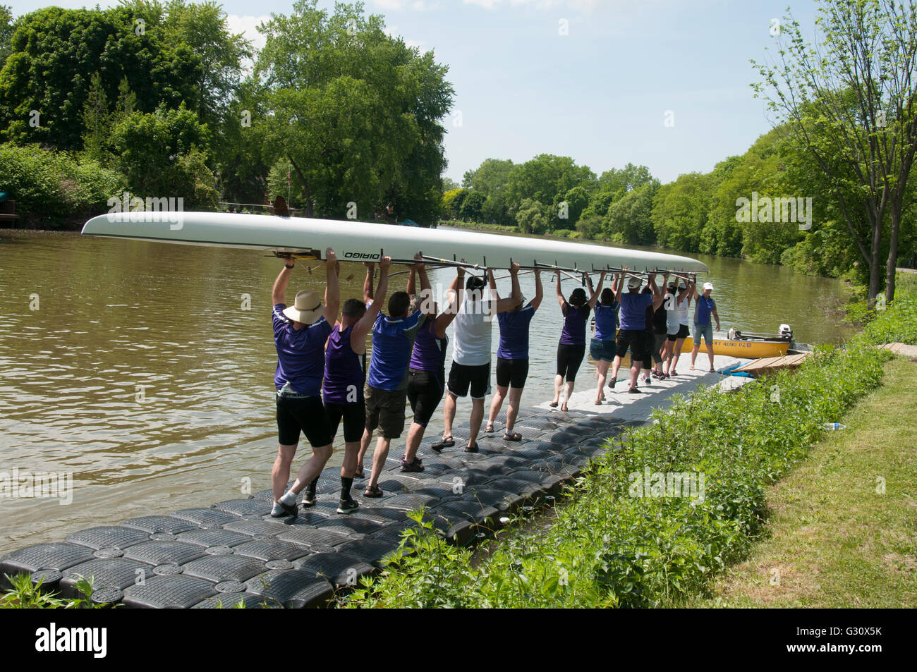 Rowing crew removing shell from water Stock Photo - Alamy