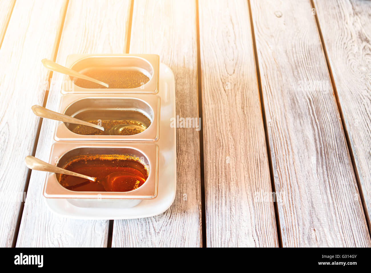 Sauce containers and spoons Stock Photo - Alamy