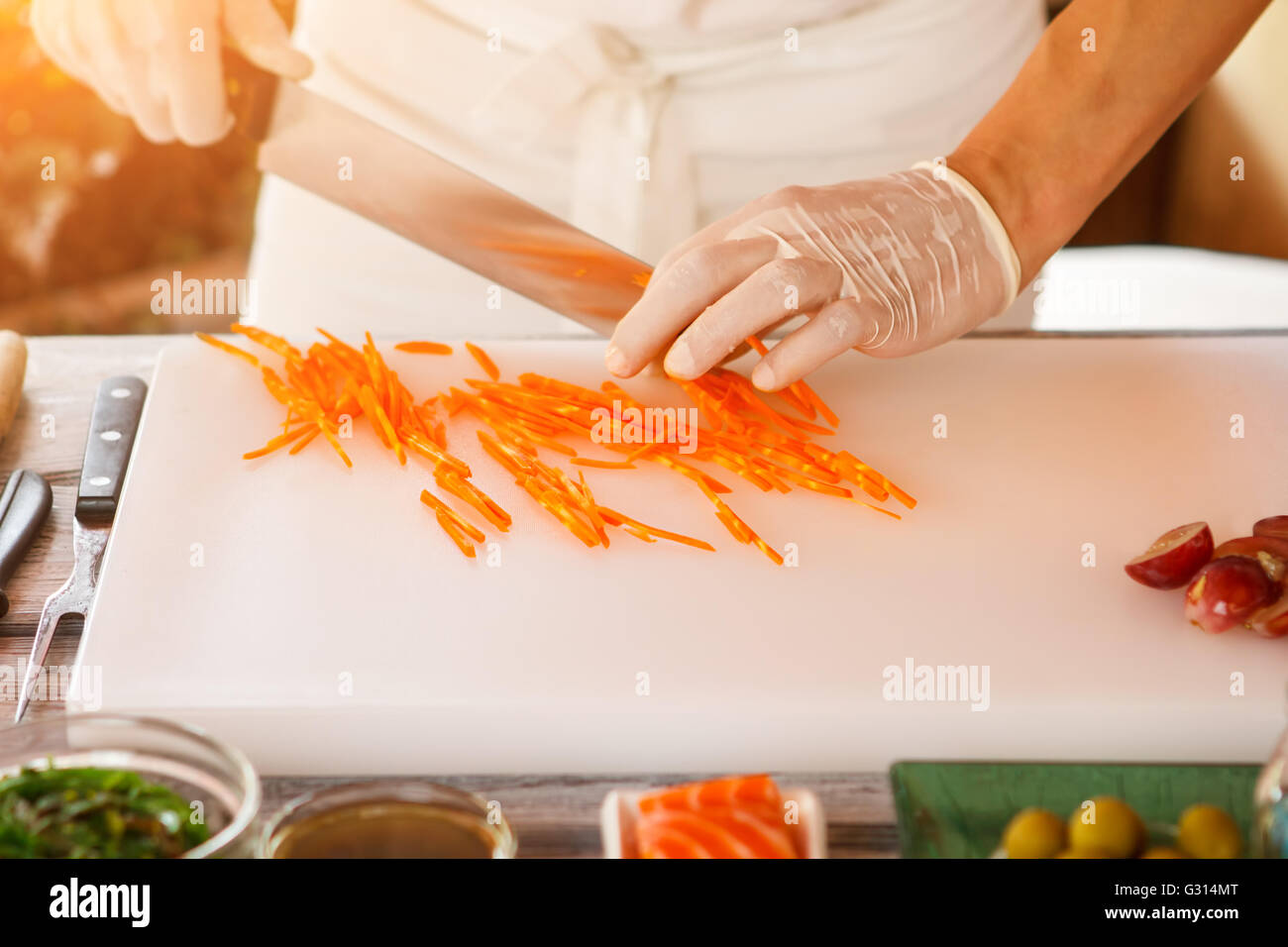 Hands with knife cutting carrot Stock Photo - Alamy
