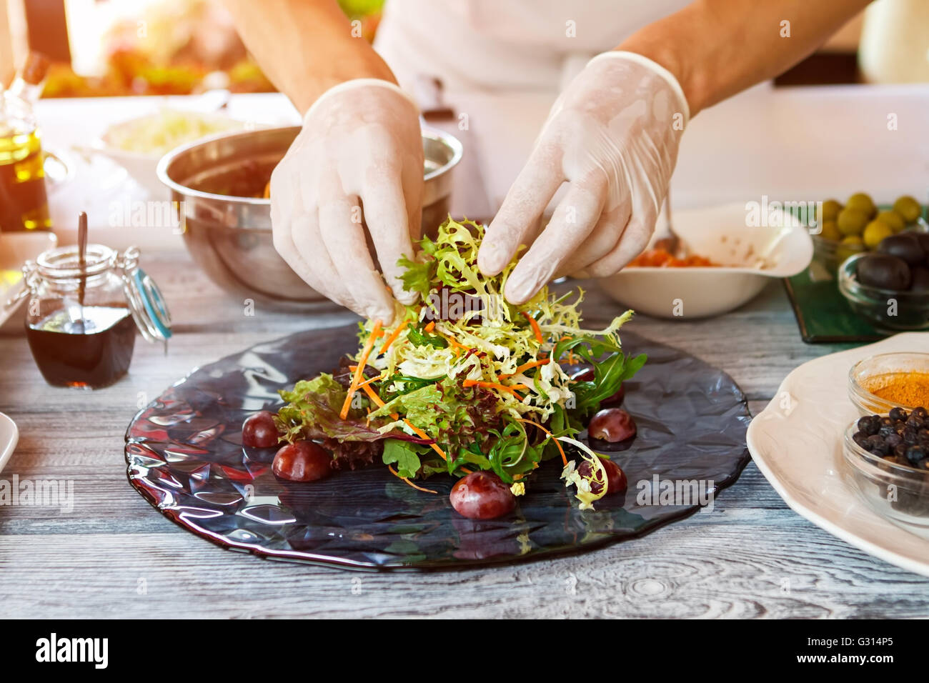 Hands touch salad on plate Stock Photo - Alamy