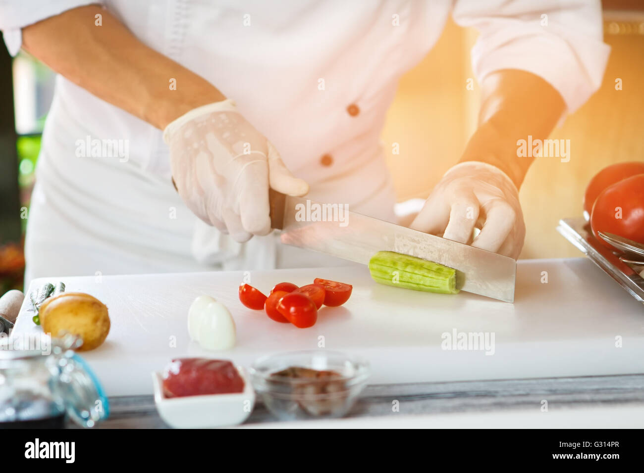 Male chef hand cutting tomato hi-res stock photography and images - Alamy