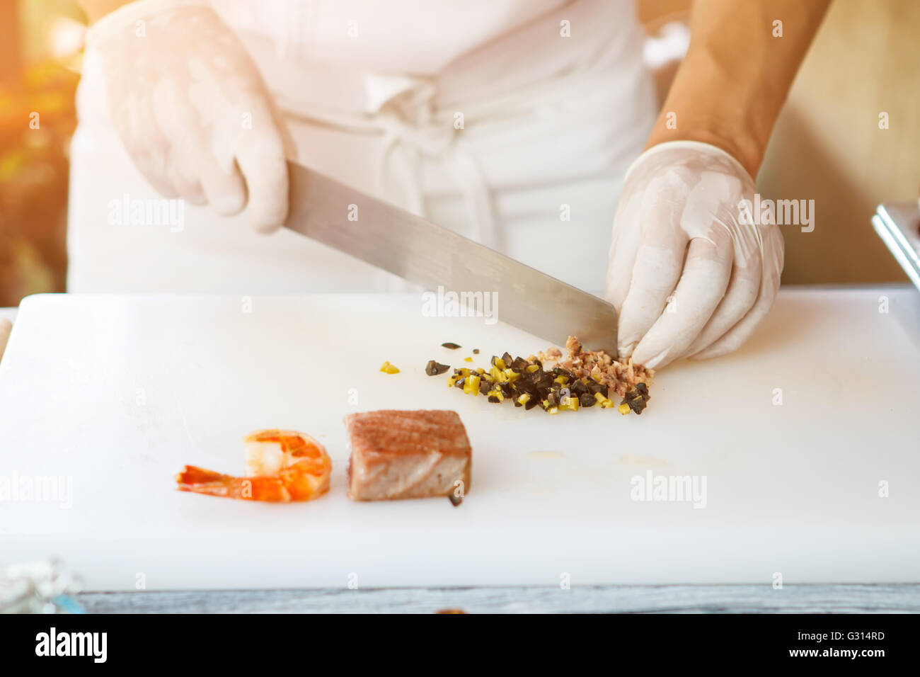 Hands with knife cutting olives Stock Photo - Alamy
