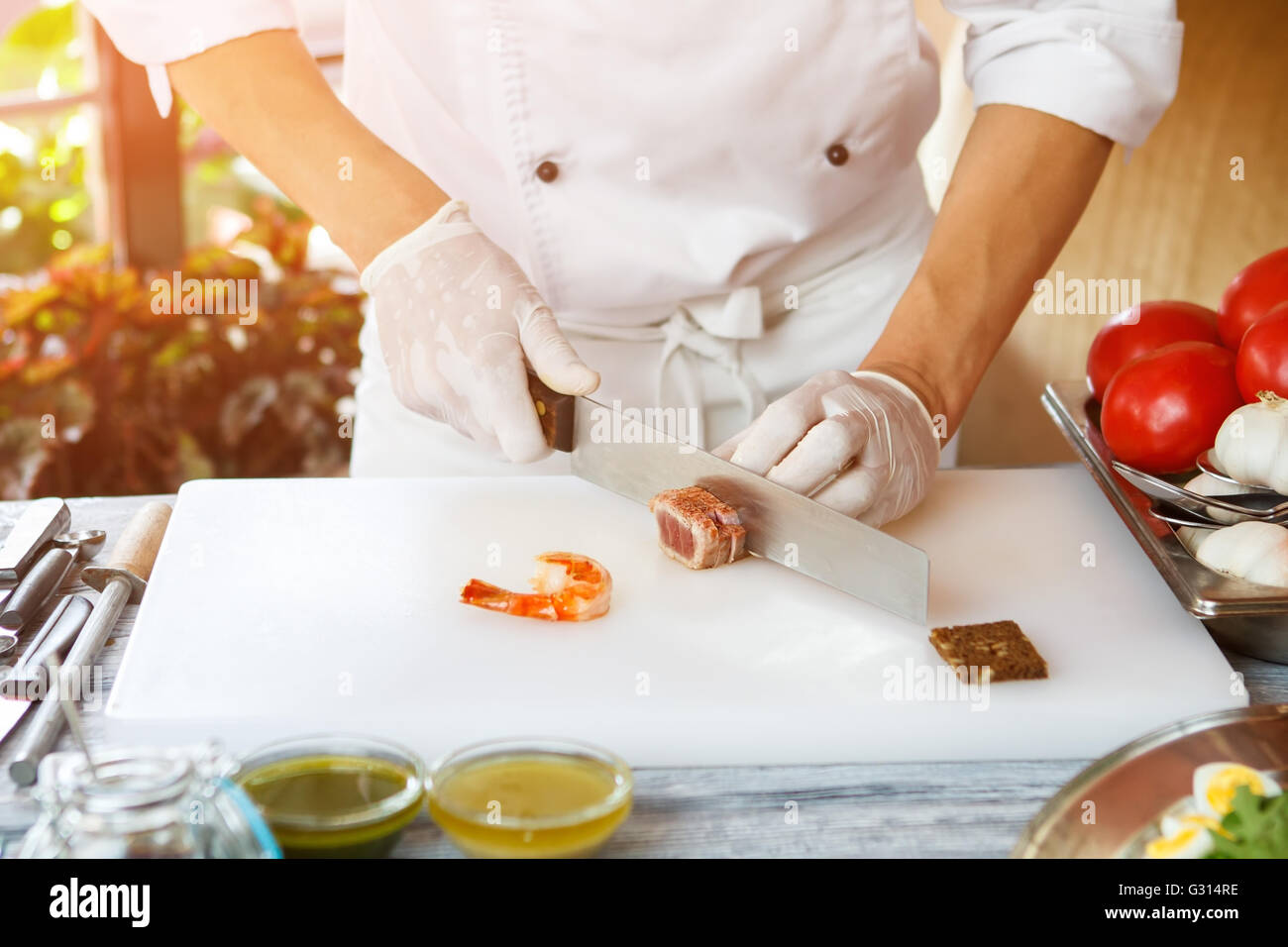 Hand with knife cutting meat Stock Photo - Alamy