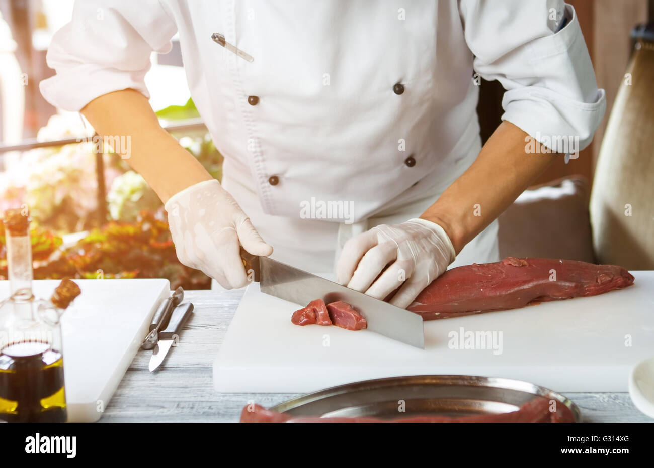 Man cutting meat with knife Stock Photo - Alamy