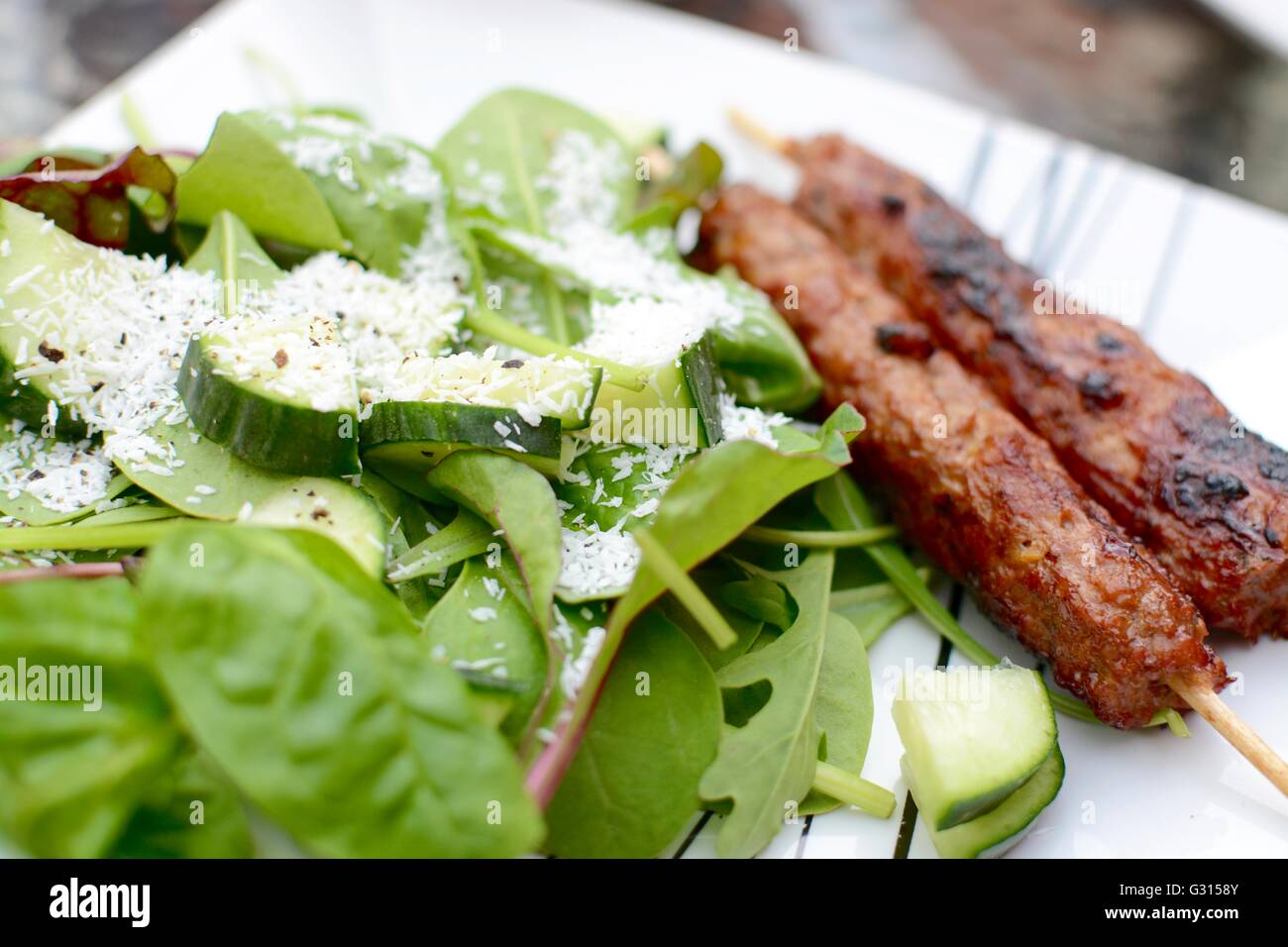 Kebab sticks served with a green salad Stock Photo - Alamy