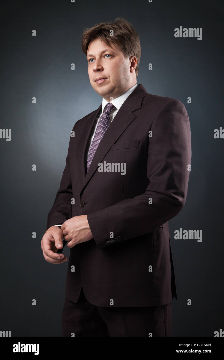 Portrait of serious businessman looking away Stock Photo - Alamy