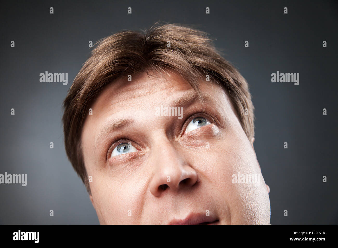 Curious adult man looking up Stock Photo - Alamy