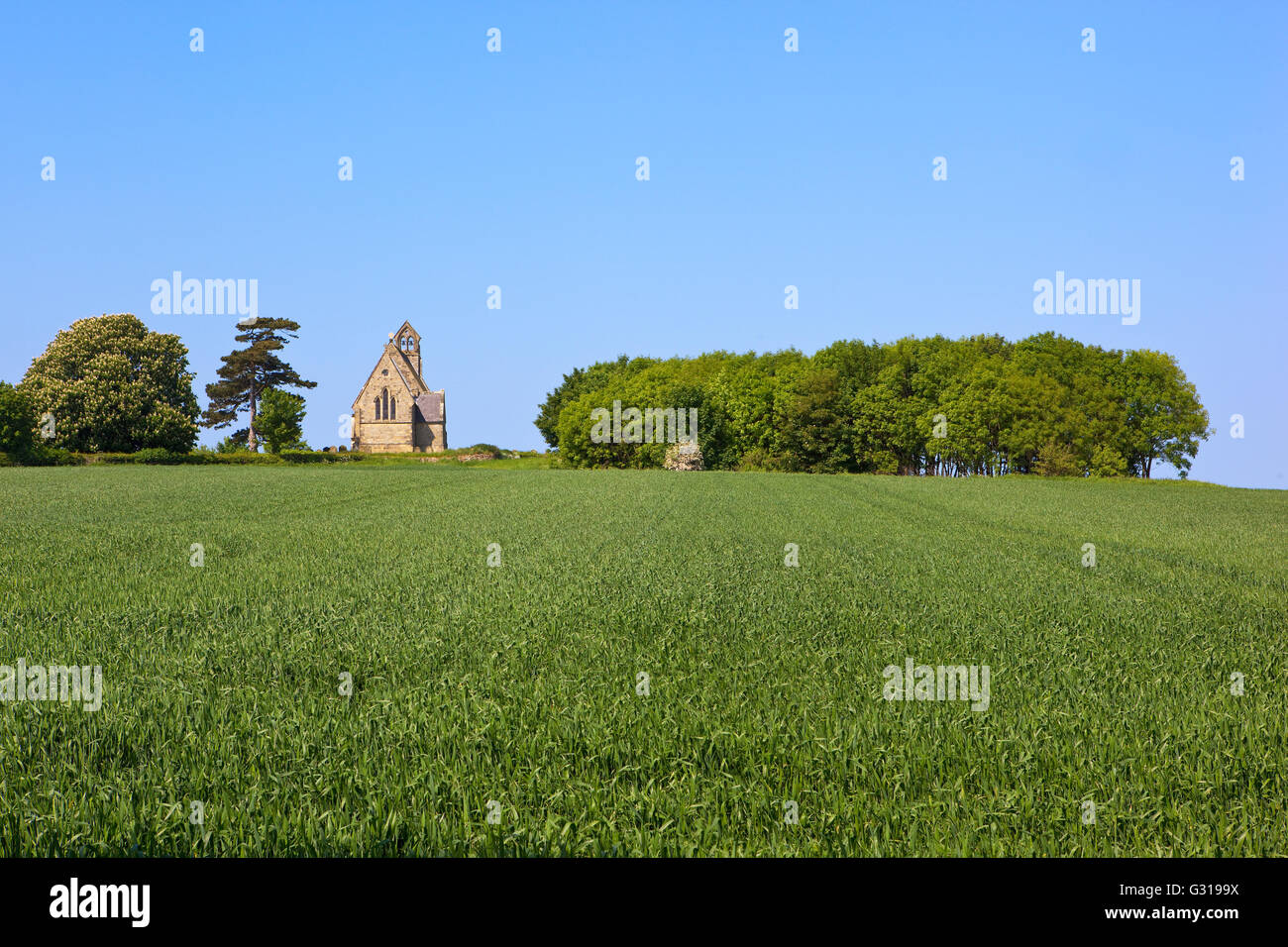 English summer landscape with a rural church on a hill viewed across a ...
