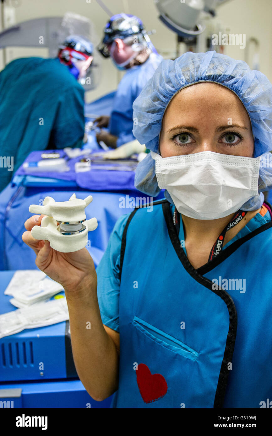 A surgical device company representative demonstrates a spinal disc ...