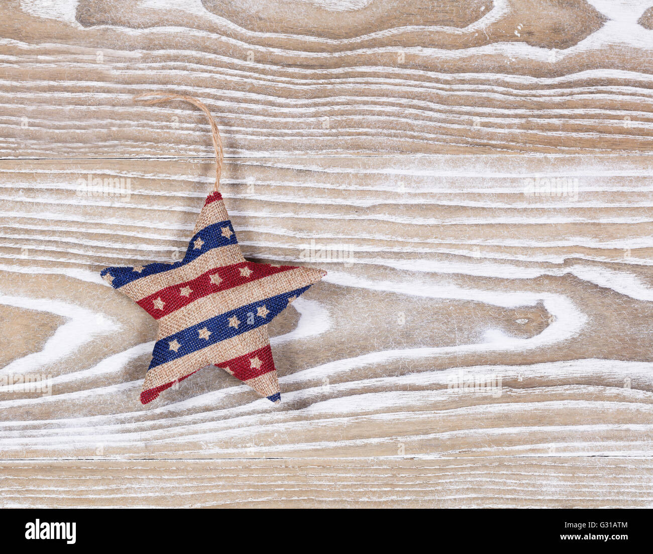 Stuffed star object in USA national colors on rustic white wooden ...