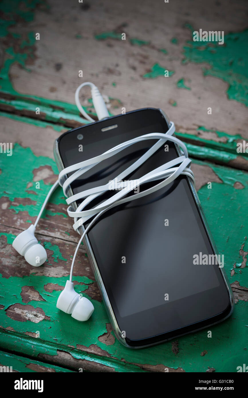 Mobile phone with headphones Stock Photo - Alamy