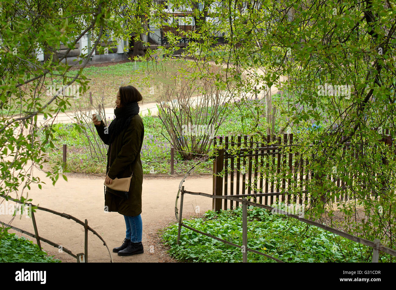 Standing girl with phone On the path from top Stock Photo - Alamy