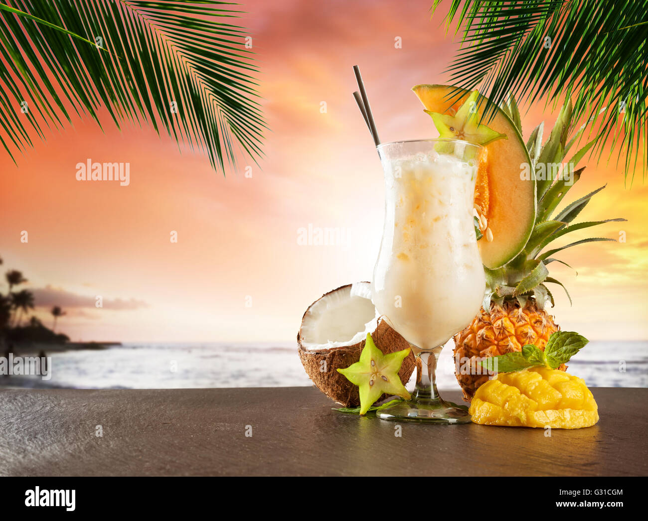 Summer cocktail with blur beach on background Stock Photo - Alamy