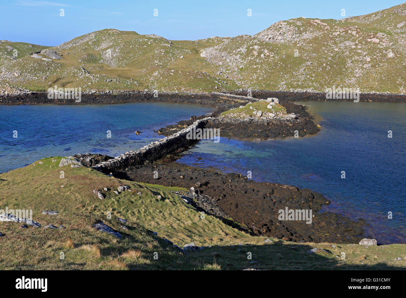 Stone wall creating an old lobster pool on the Island of Pabay Mor in ...