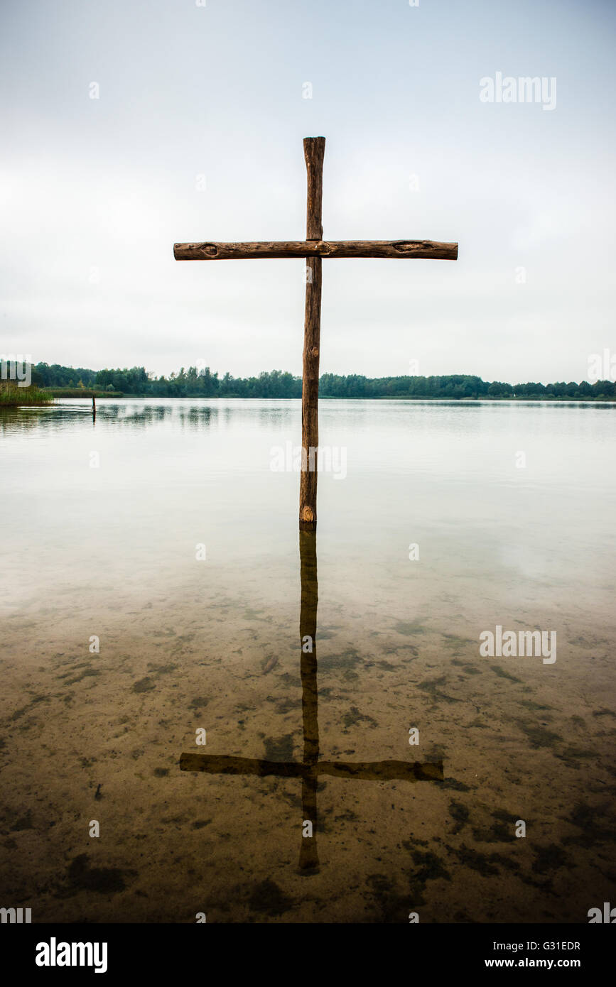 The cross is standing in the water, symbol for washing off our sins by ...