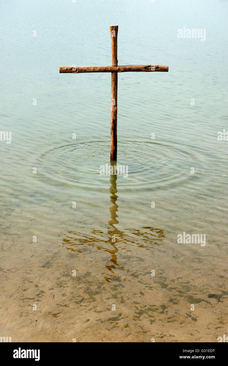 The cross is standing in the water, symbol for washing off our sins by ...
