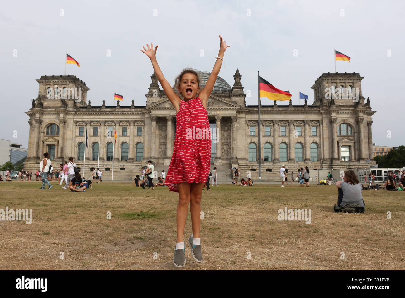 Berlin, Germany, little girl jumps before the Reichstag building ...