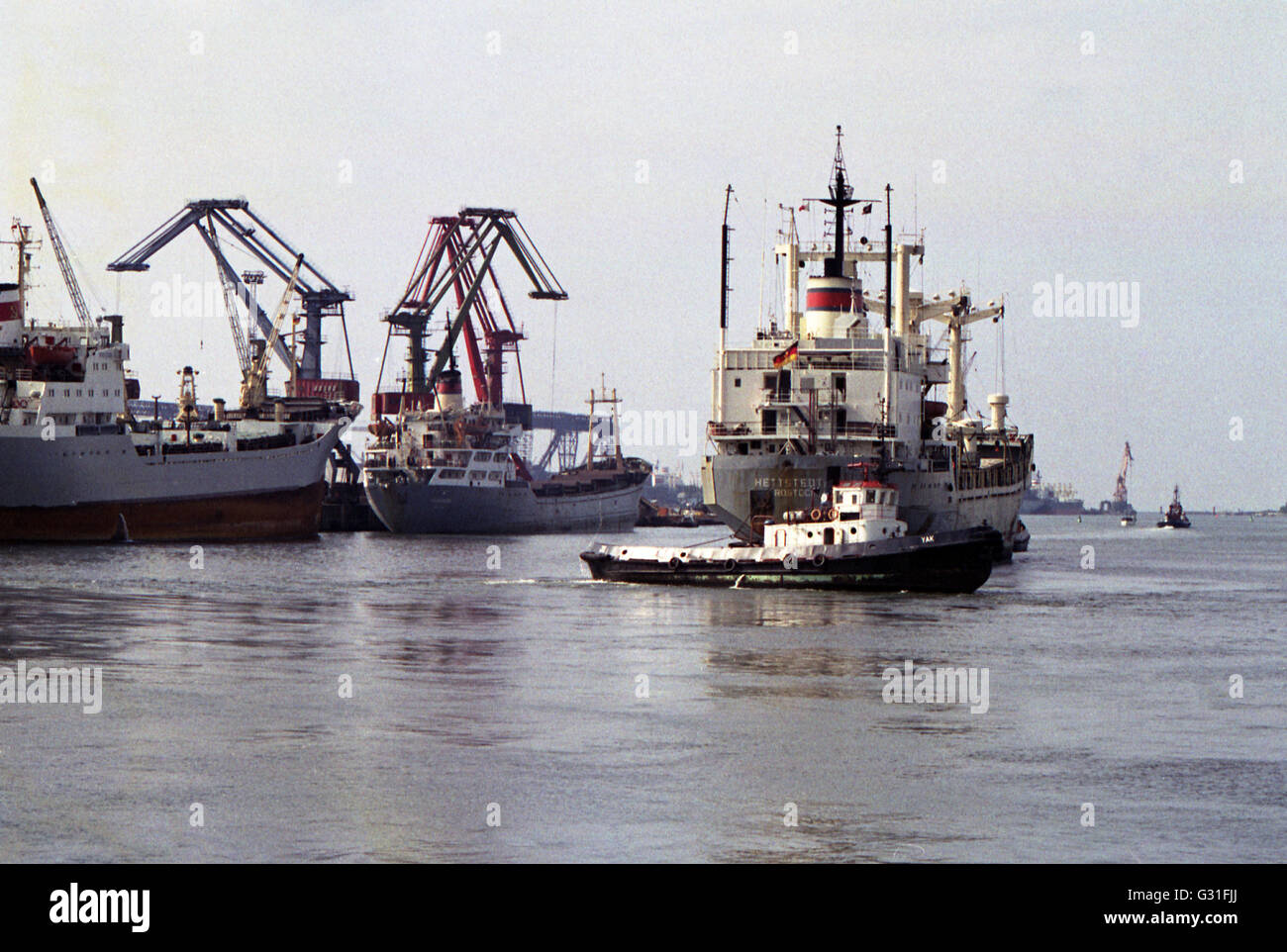Rostock, DDR, cargo ships and tugs in Ueberseehafen Rostock Stock Photo ...