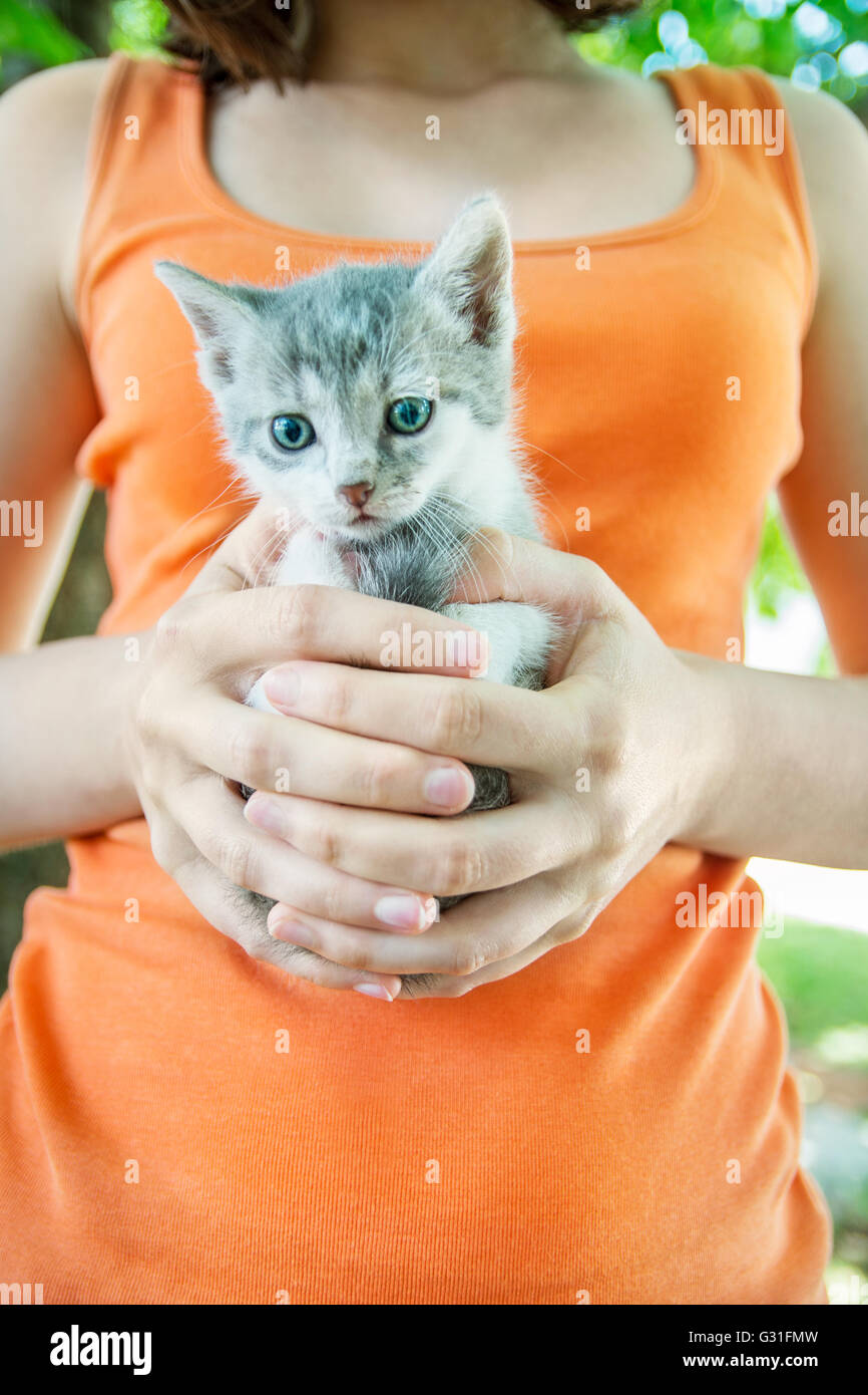 Girl holds cat on hand Stock Photo - Alamy