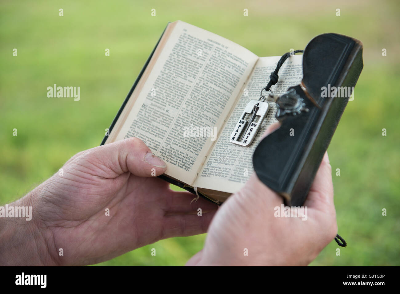 Man reading a bible outside Stock Photo - Alamy