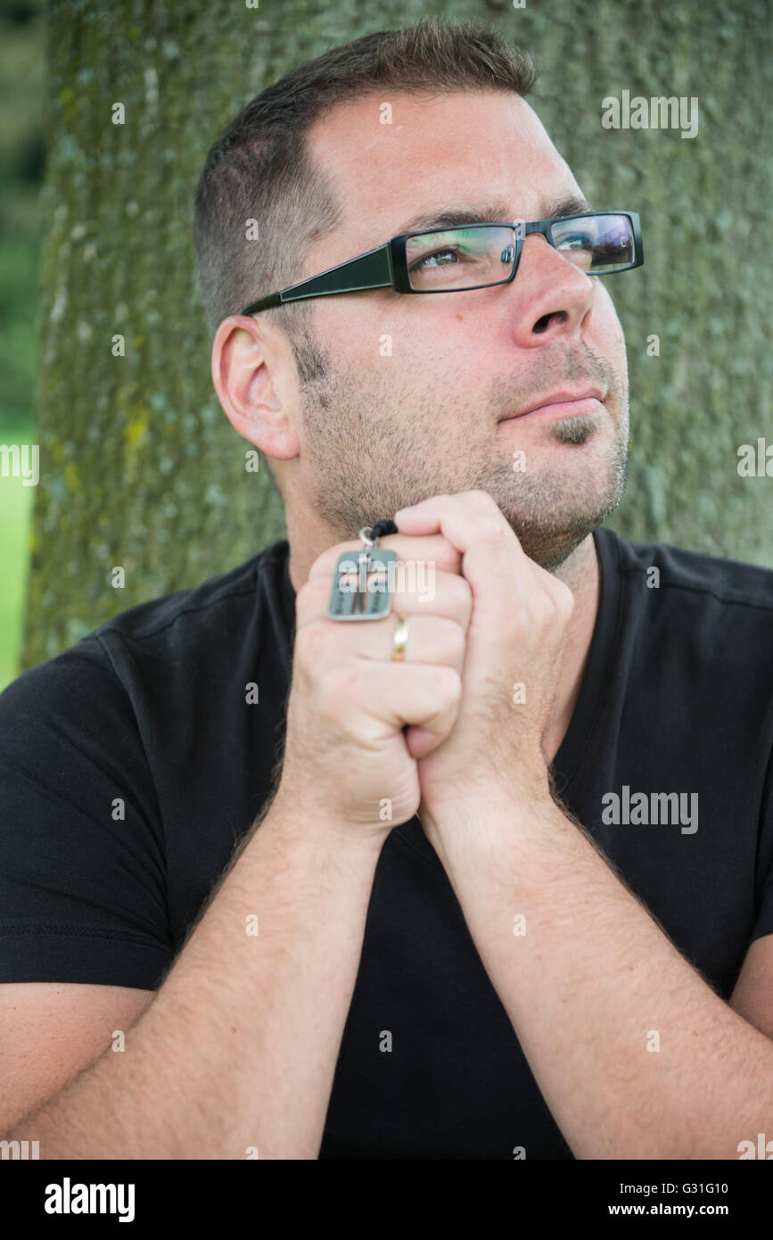 Man praying outside Stock Photo - Alamy