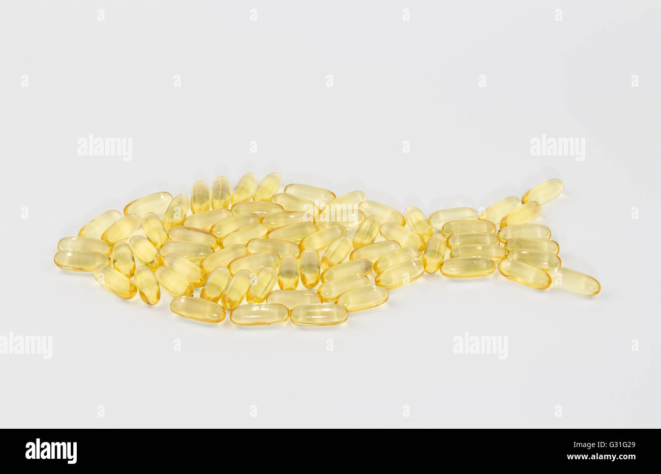 Omega 3 and 6 fish oil capsules formed into a fish shape isolated on ...