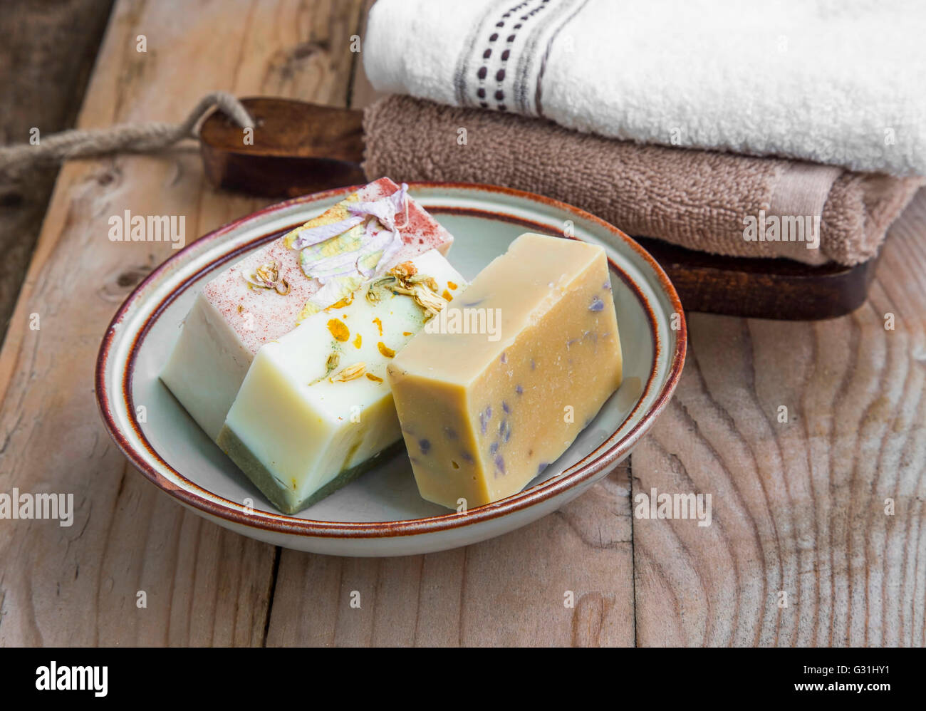 Natural soaps spa setting with towels Stock Photo - Alamy